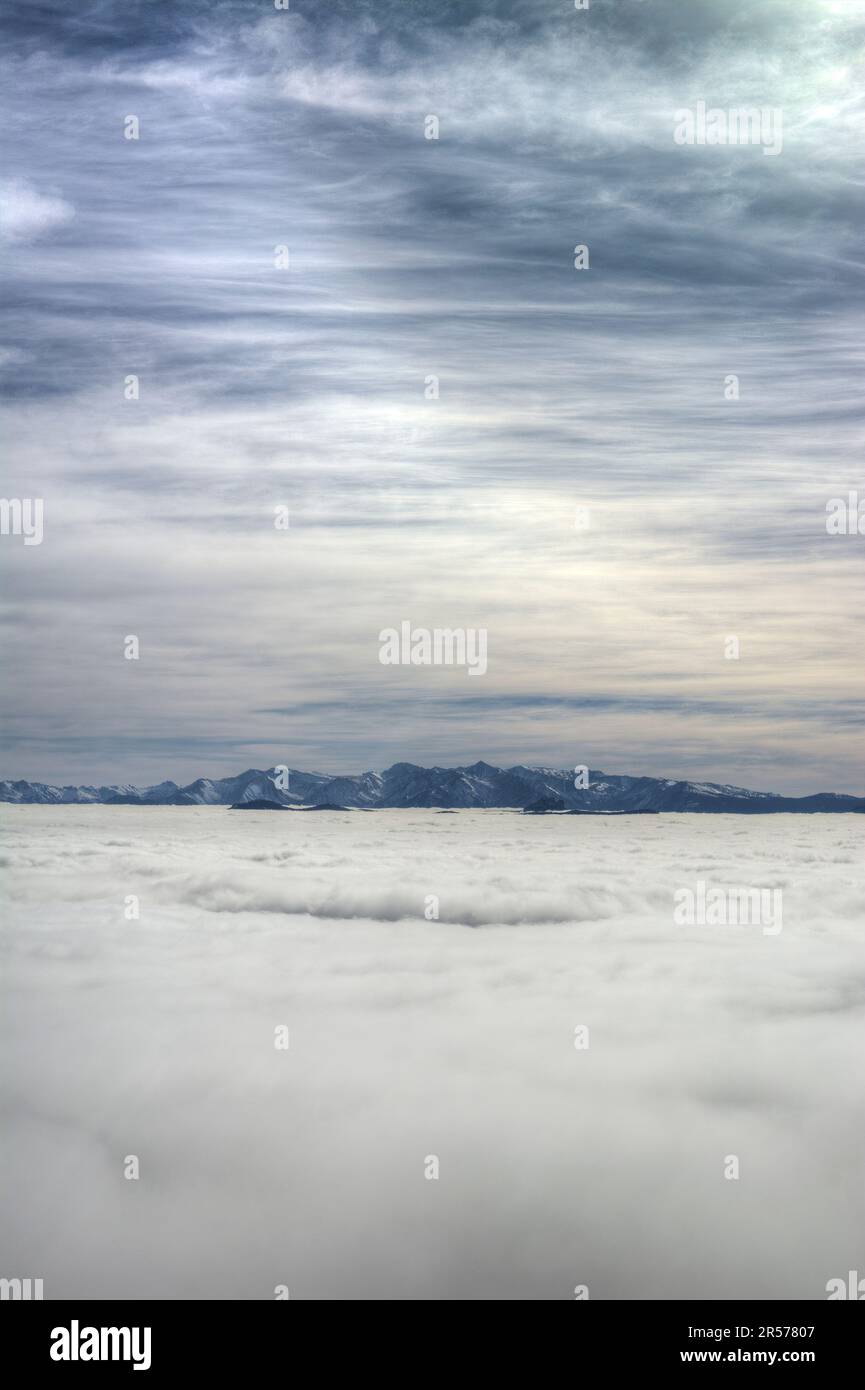 Mountain valley shrouded in fluffy snow-white clouds at dawn near Bariloche, Argentina Stock ...