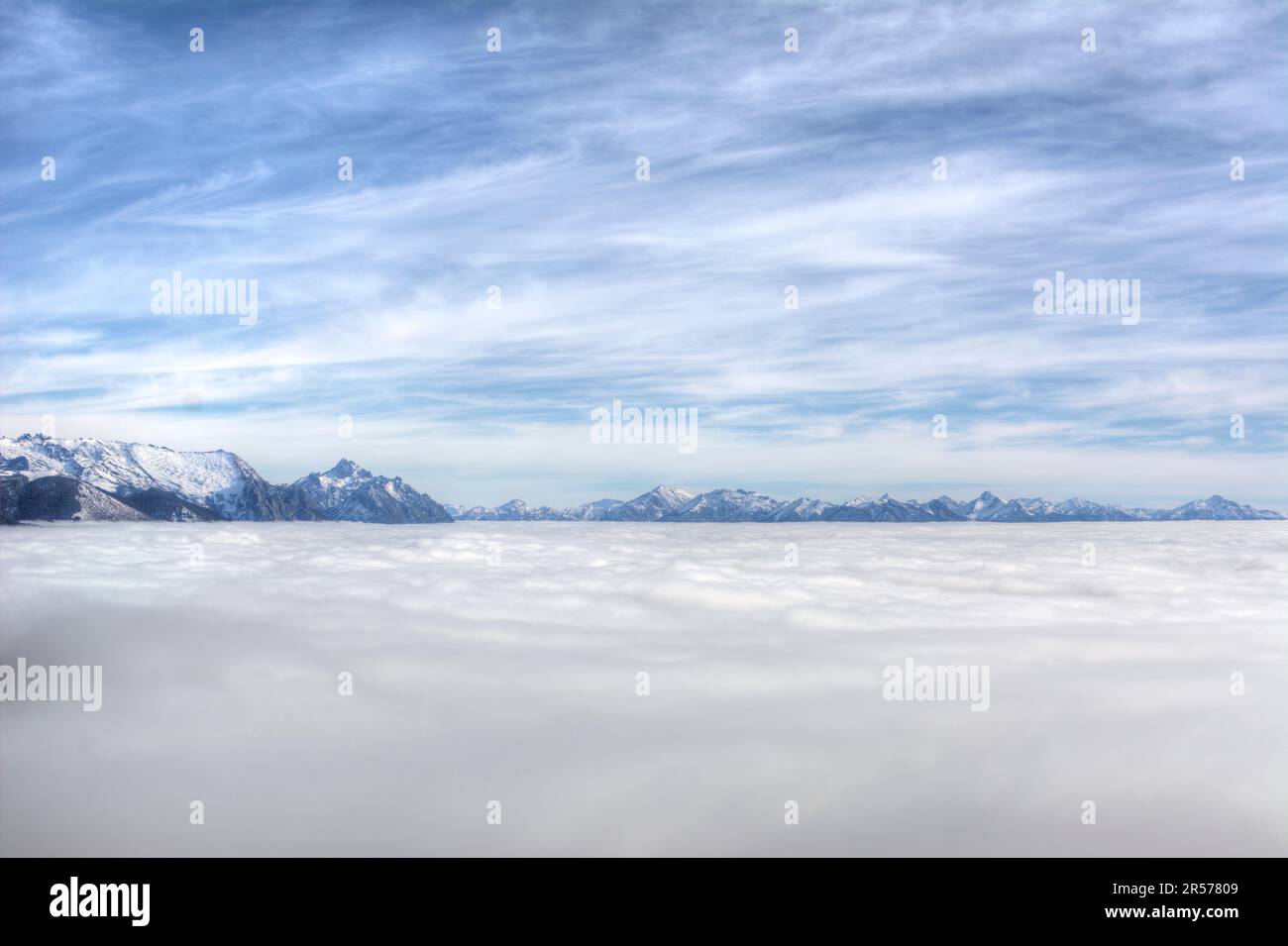 Mountain valley shrouded in fluffy snow-white clouds at dawn near Bariloche, Argentina Stock ...