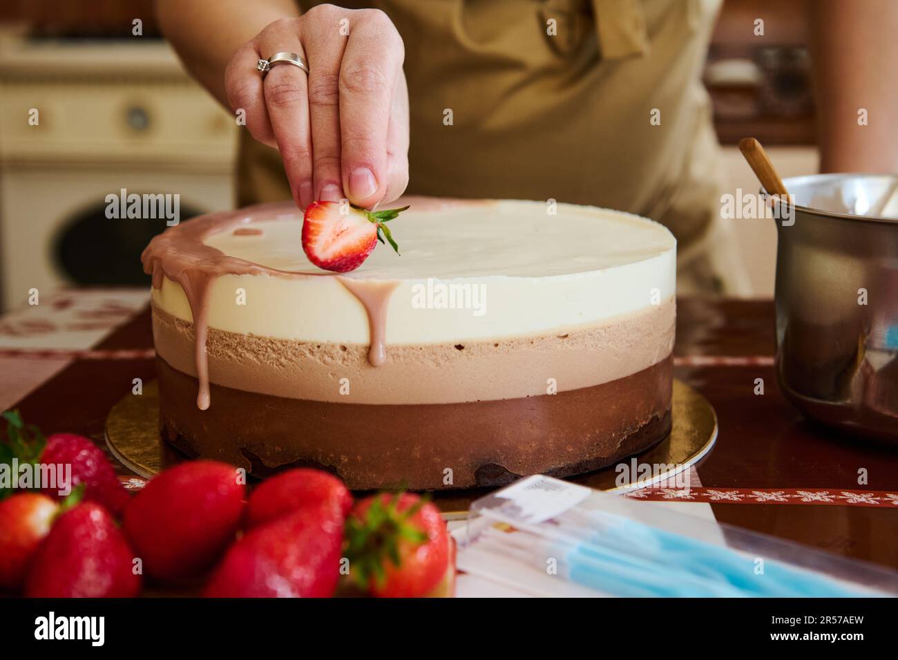 Close-up view of chef confectioner decorating the three chocolate ...