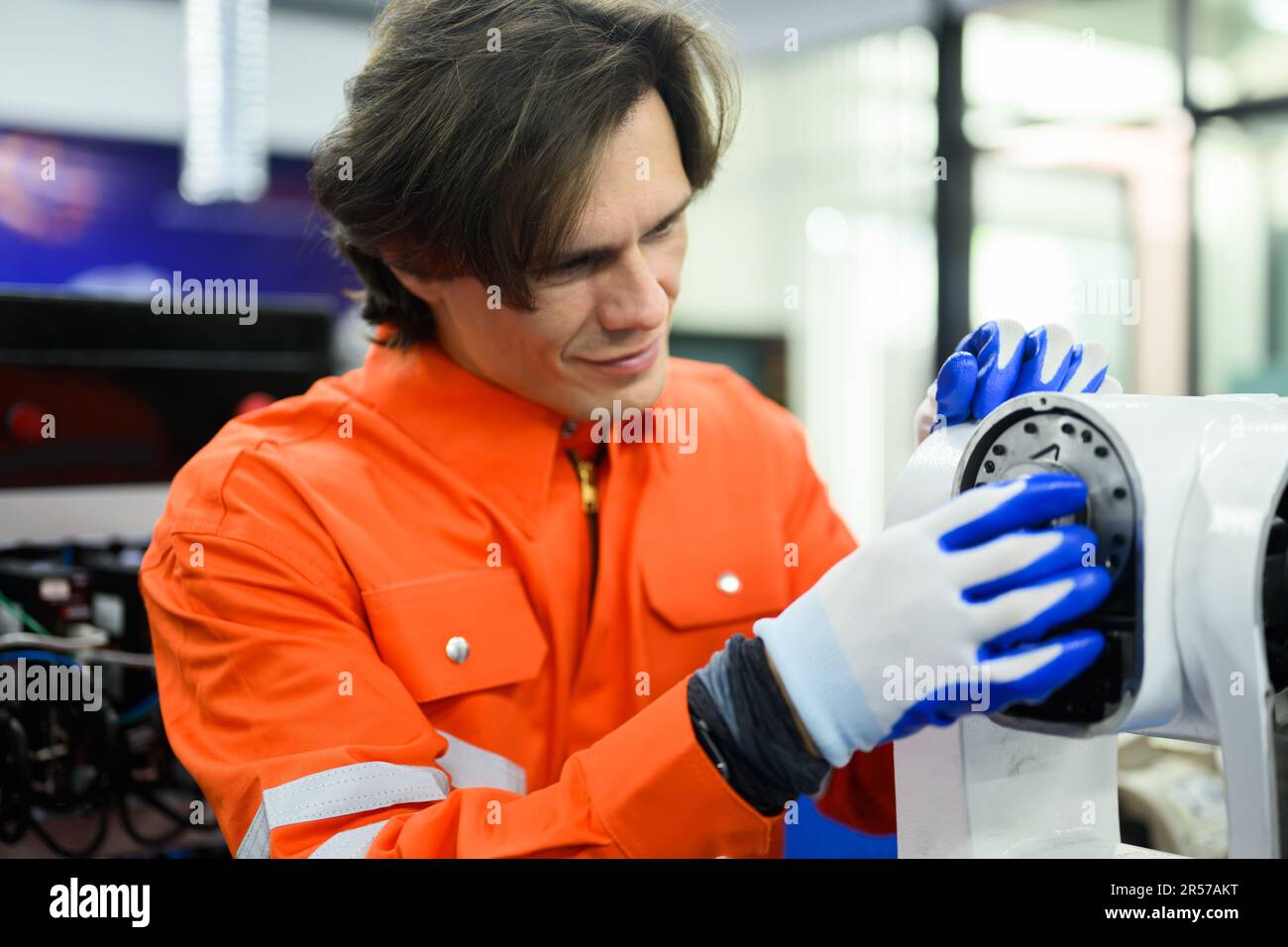 Engineer working and solving problems on machine at industrial plant ...