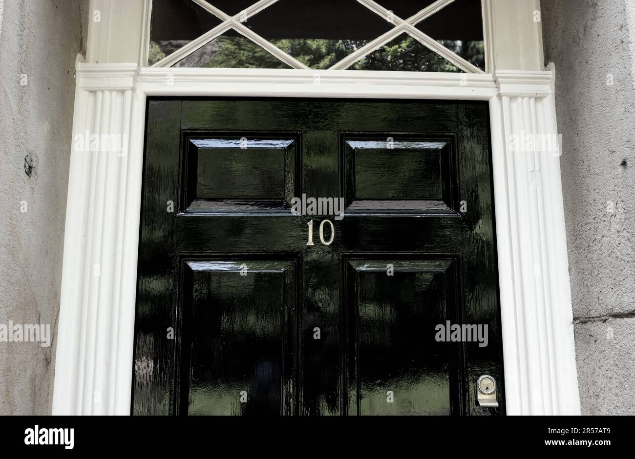 Black painted wooden panel front door with number 10 and white wooden ...