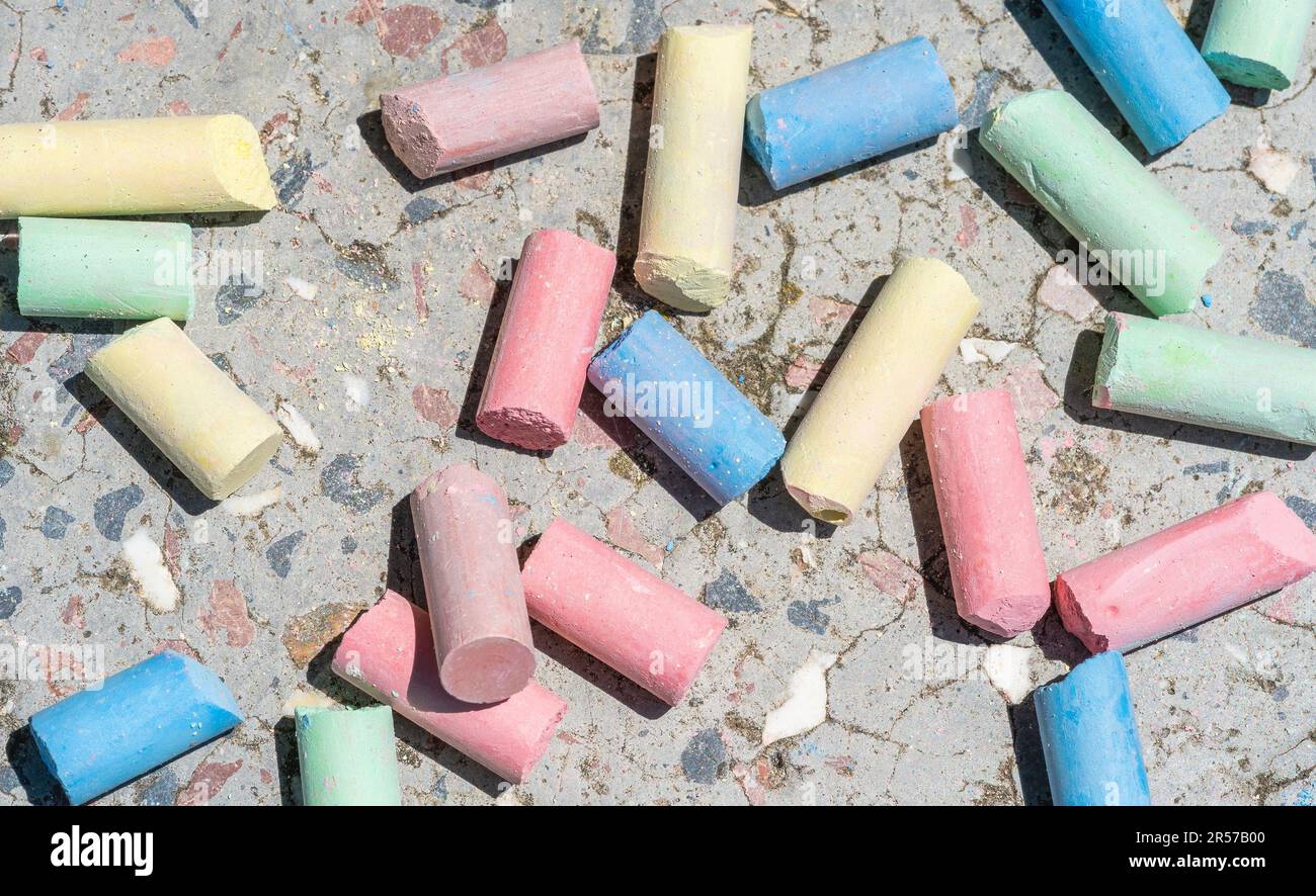 Broken colored chalks scattered on a concrete slab Stock Photo - Alamy