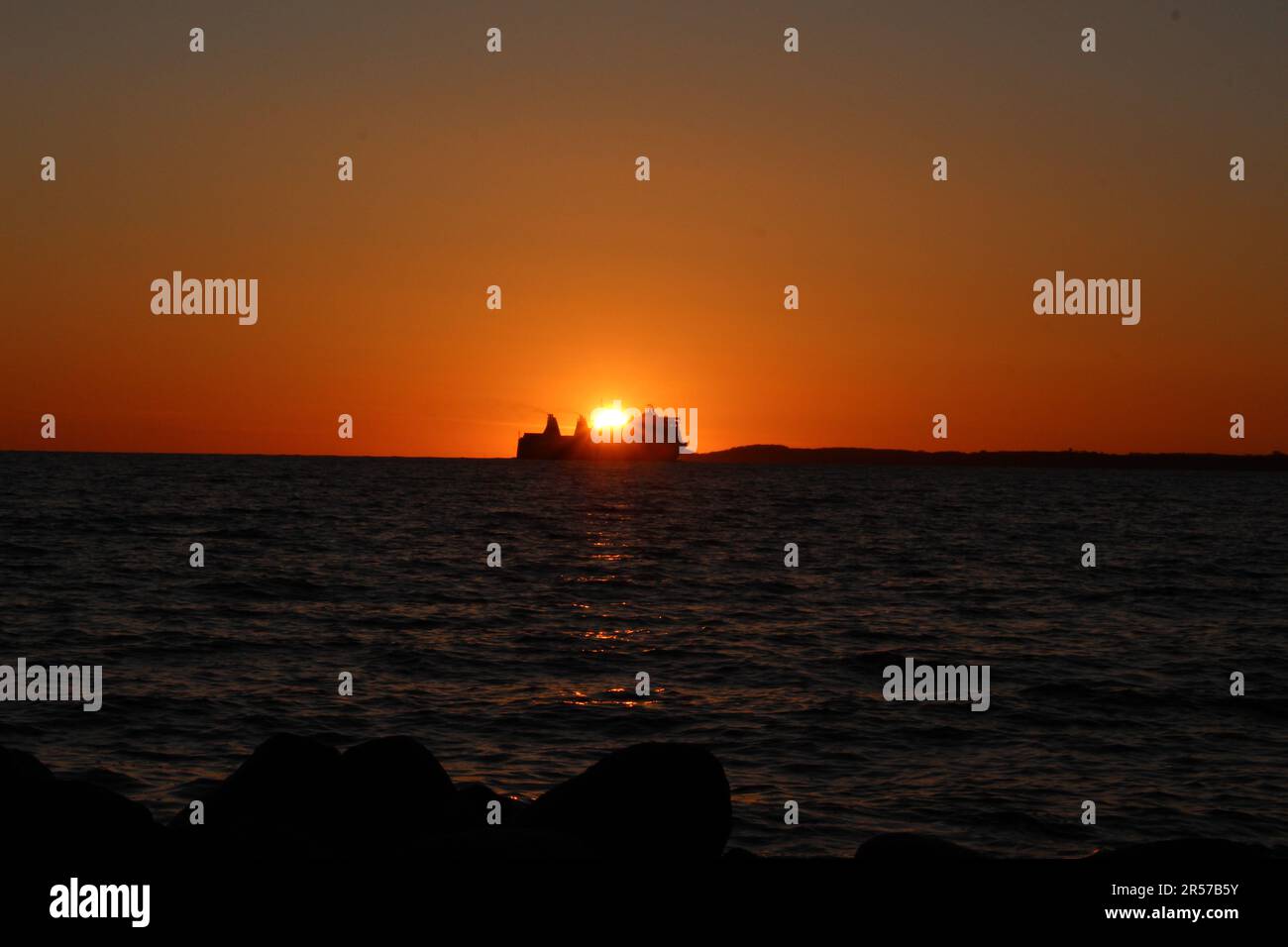 Rising Sun with a Ship in the Baltic Sea Stock Photo - Alamy