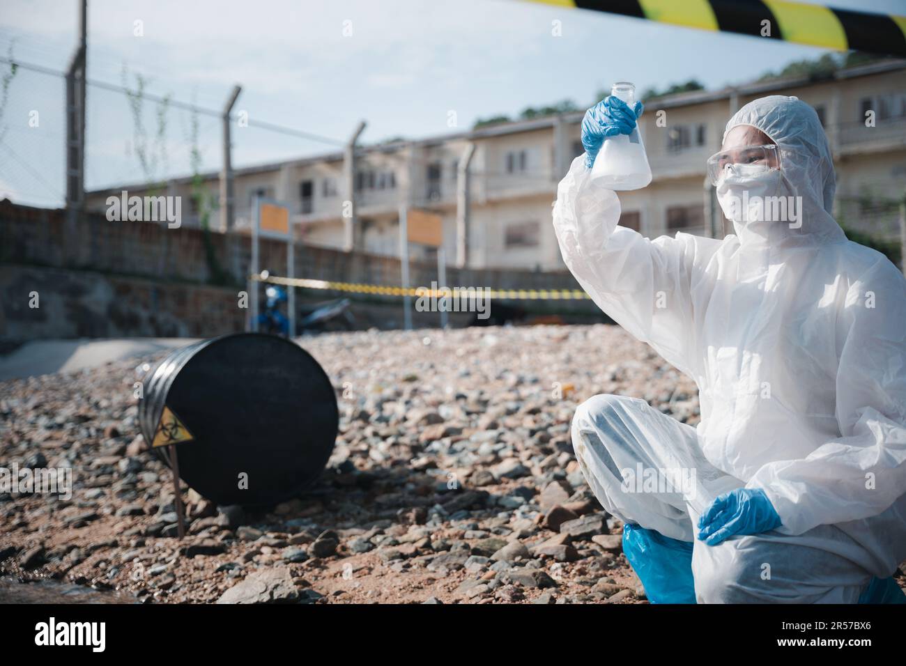 Ecologist sampling water toxic chemicals from river with test tube ...