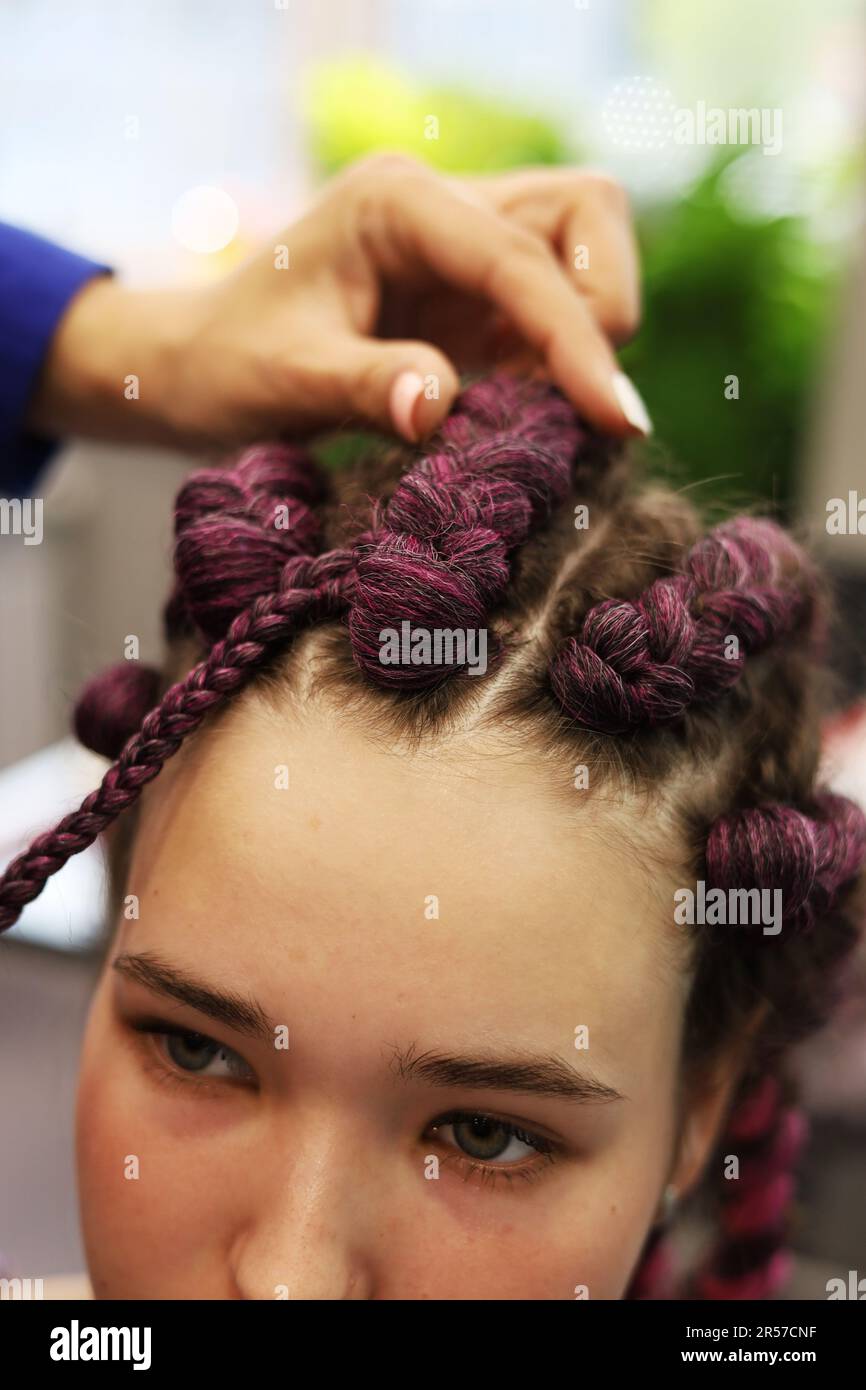 Braid the pigtails into a ponytail and an afro-tail Stock Photo - Alamy