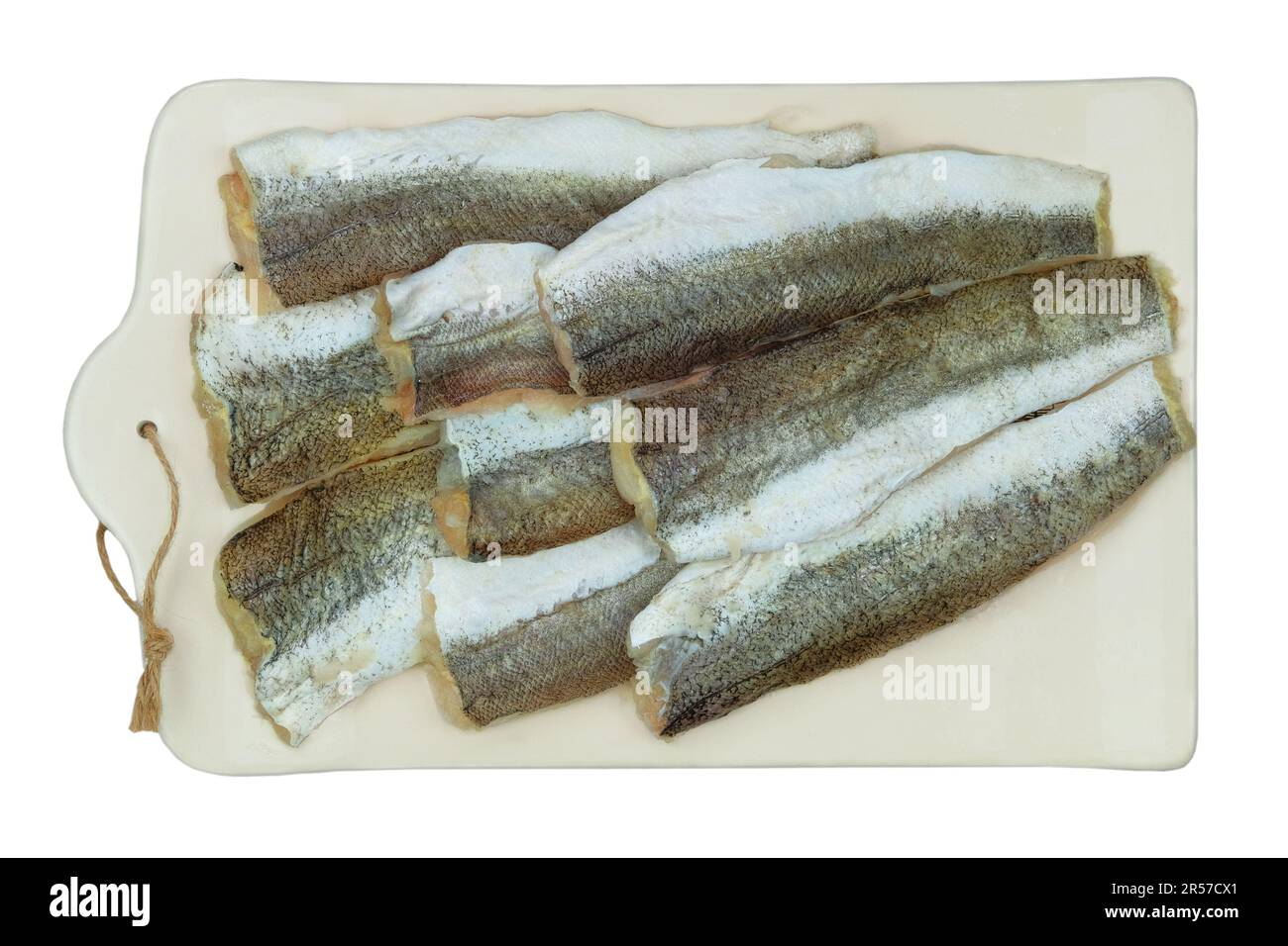 Raw hake on a ceramic board isolated on white background. Ready to ...