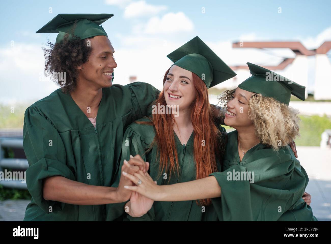 Group of friends celebrating their graduation together outdoors at the ...