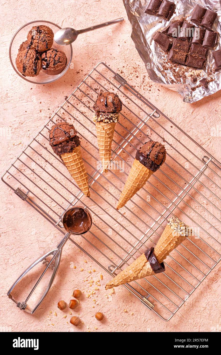 Chocolate ice cream on a metal rack with scoop from stainless steel ...