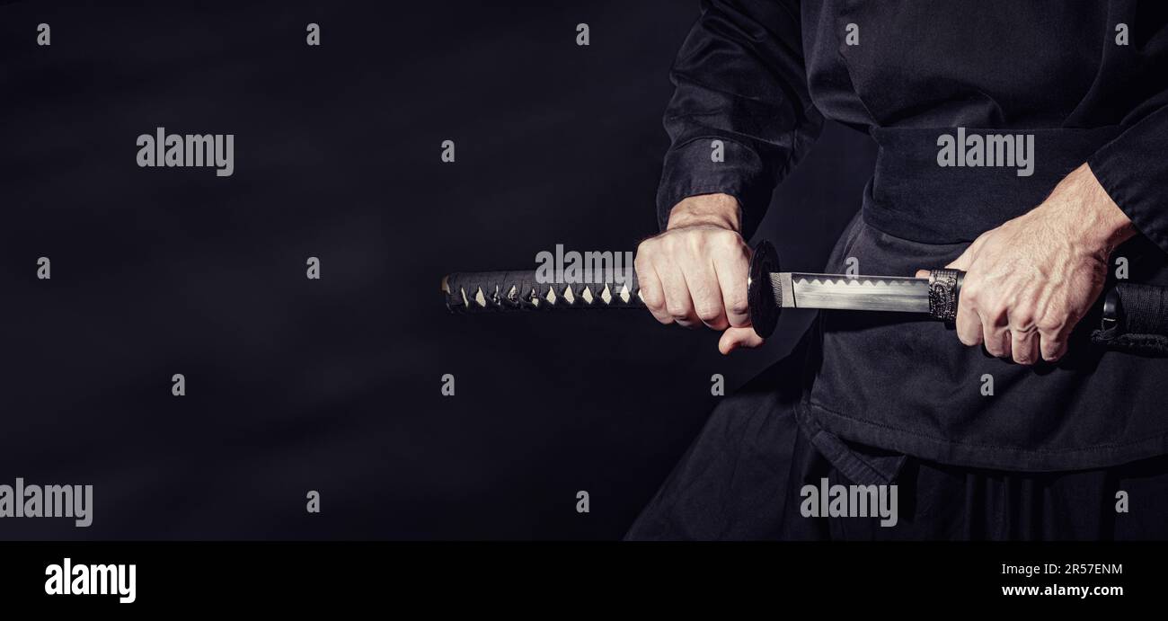 The samurai holding a Japanese katana sword, banner. Photo of a warrior ...