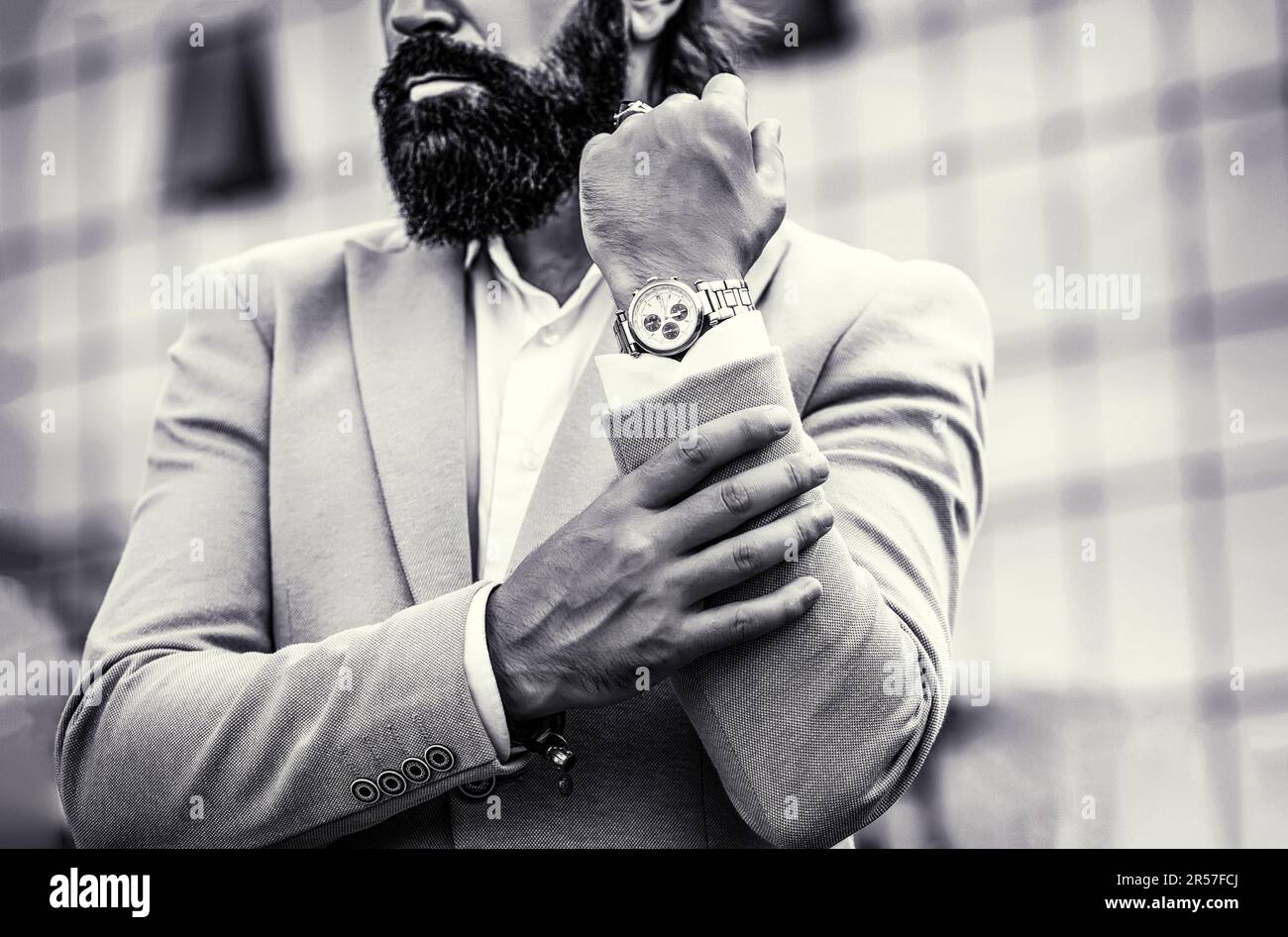 Man holds his watch. Portrait successful businessman in a business suit ...
