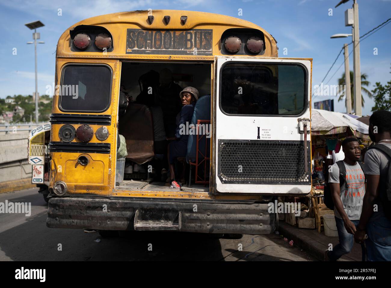 A woman sits in a school bus used as a public transportation bus in ...