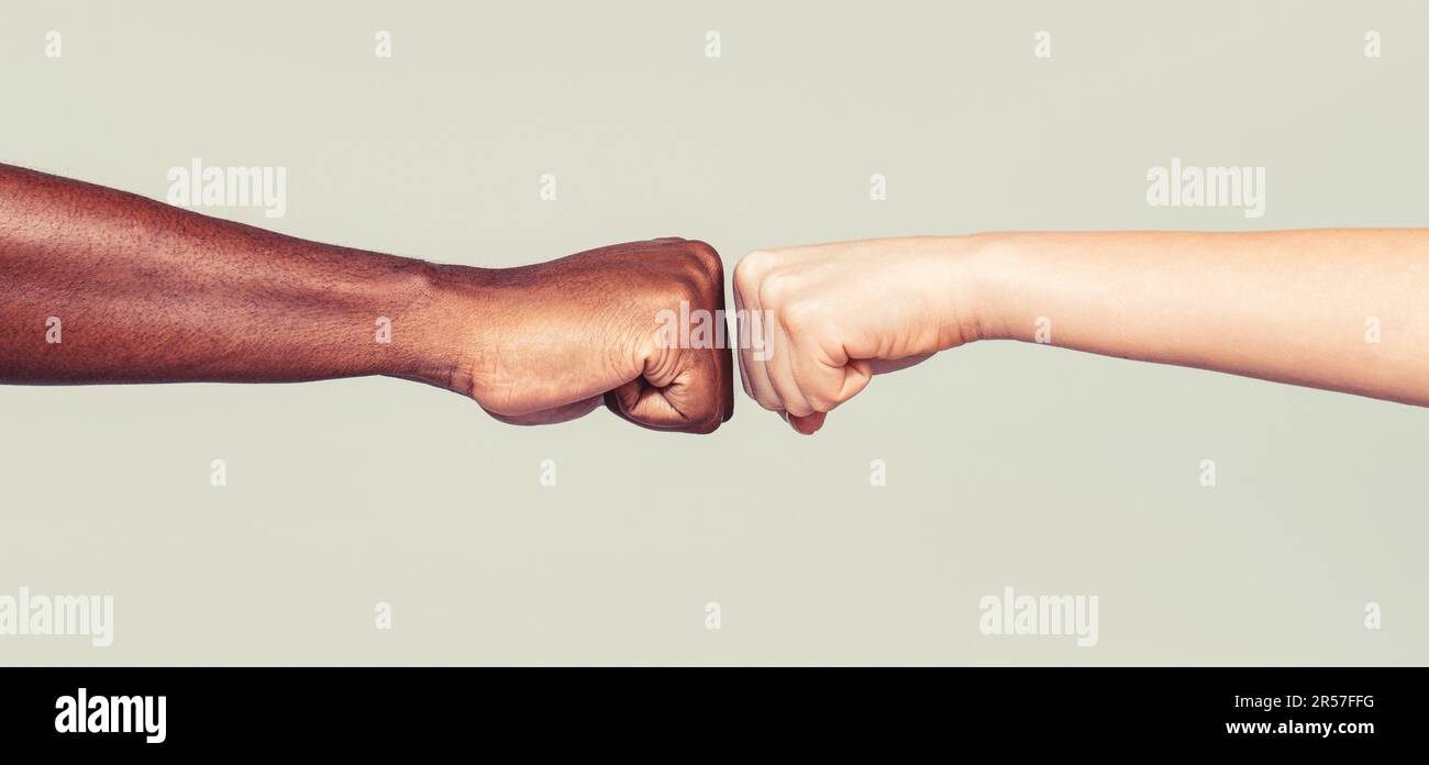 Closeup of multicultural friends giving fist bump to each other. Black ...