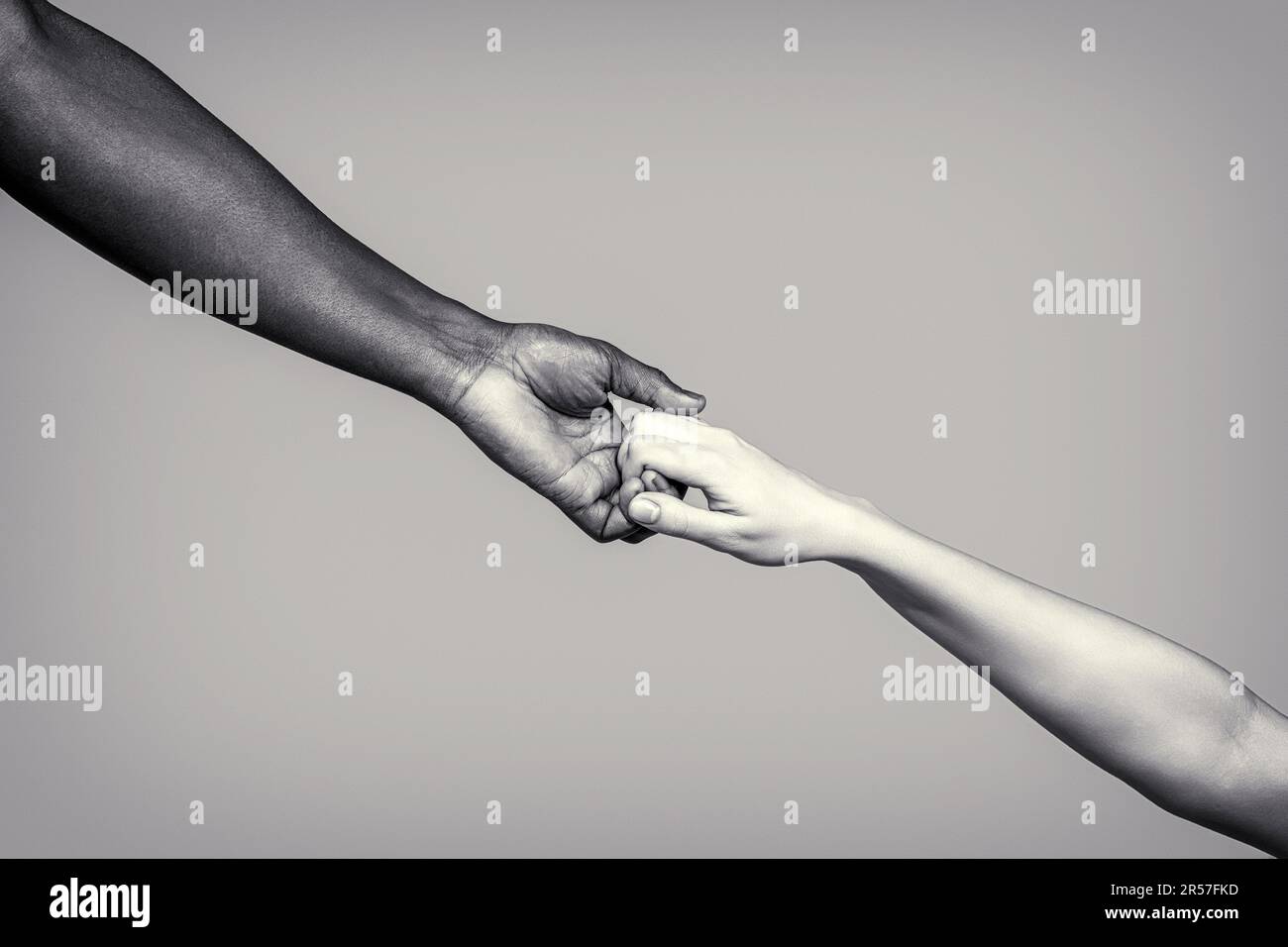 Helping hands, Rescue gesture. African and caucasian hands. Giving a ...