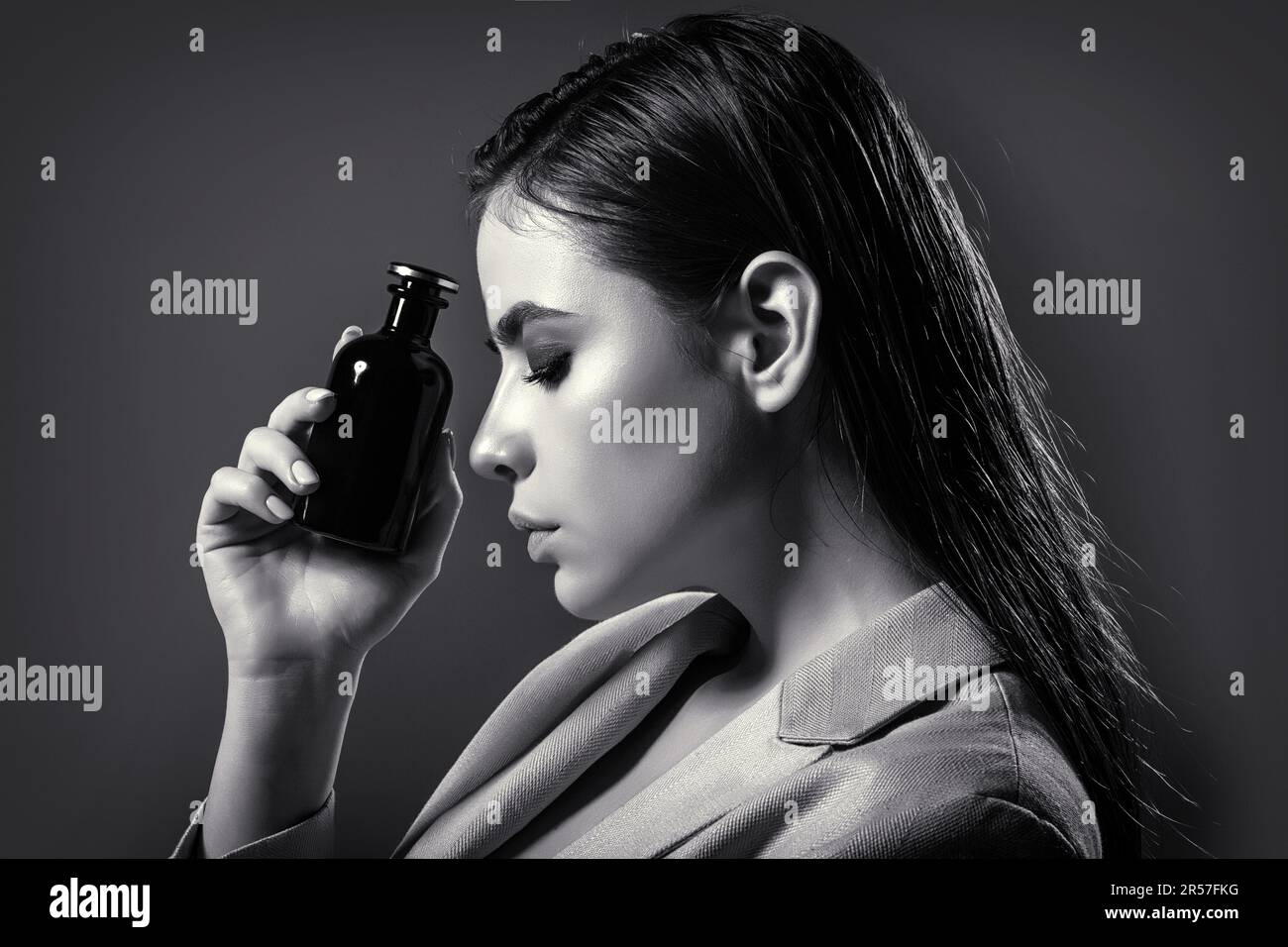 Beautiful girl using perfume. Woman with bottle of perfume. Woman ...