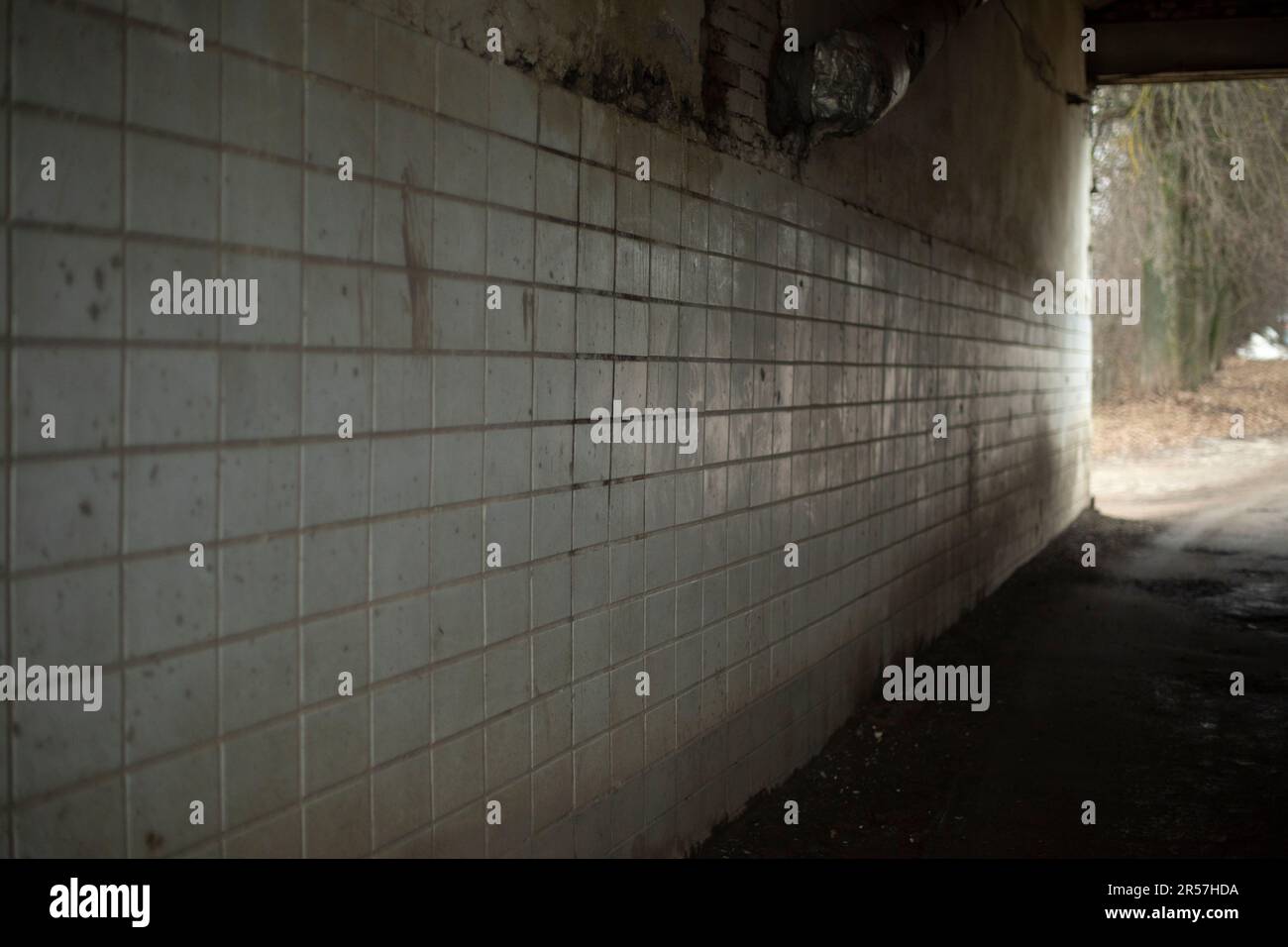 Wall in passage. Passage through industrial zone. Tile on wall. Details ...