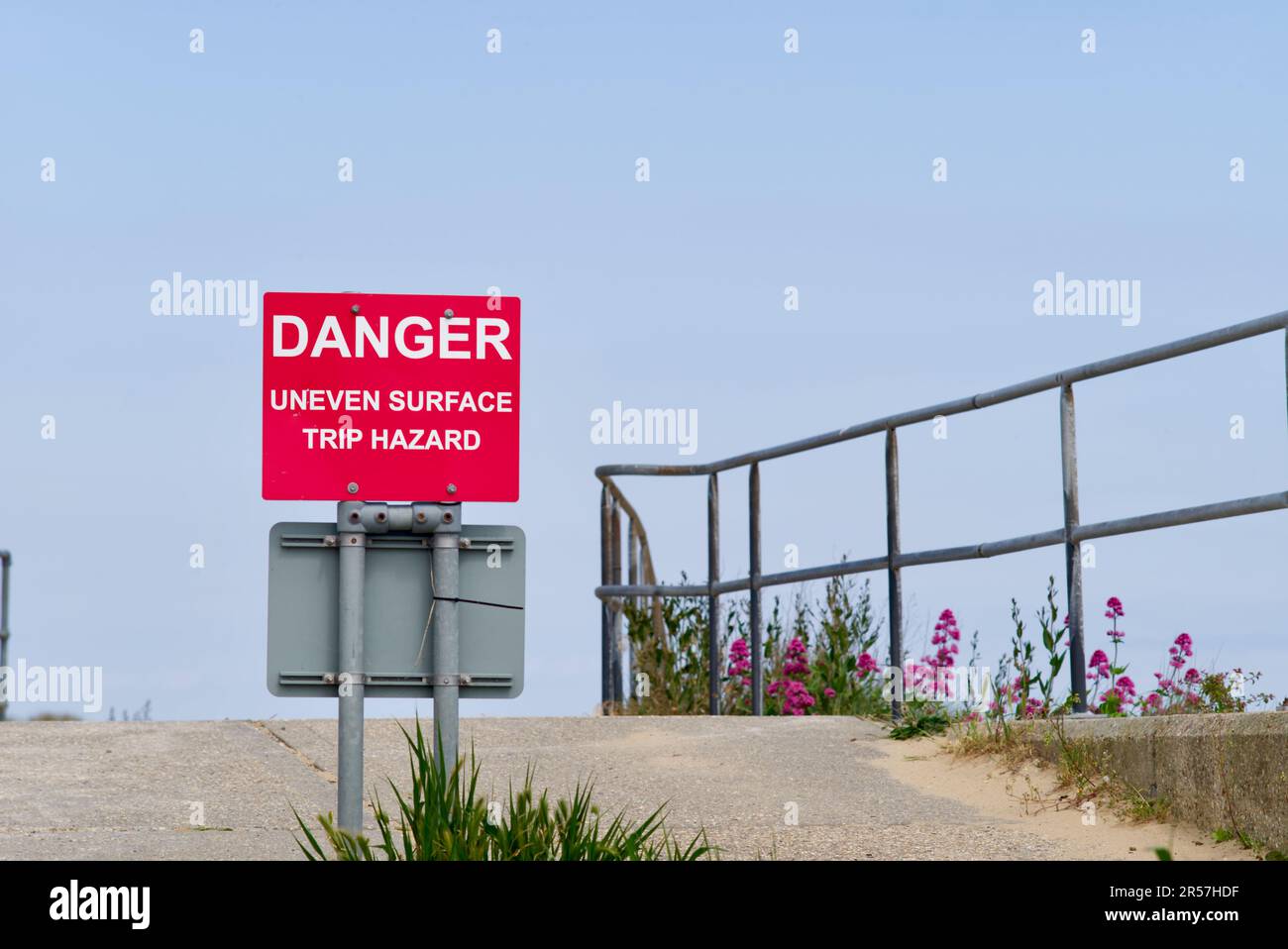 Uneven surface warning sign Martello Bay Clacton on Sea Stock Photo - Alamy