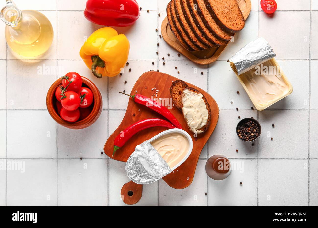 Wooden board with boxes of processed cheese, bread and vegetables on ...