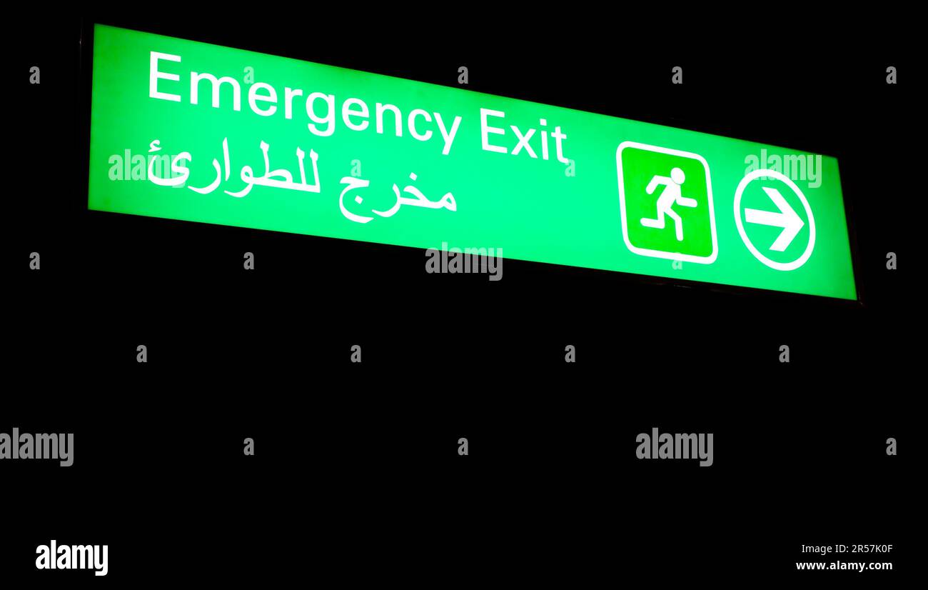 Emergency exit sign in an international airport in Middle East with ...