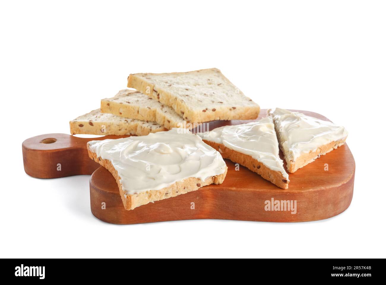 Wooden board of tasty toasts with cream cheese on white background ...
