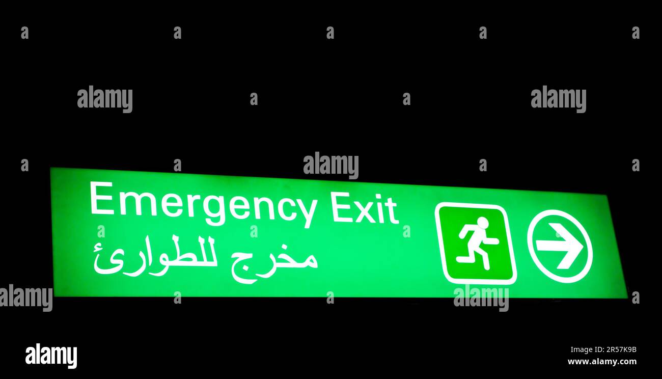 Emergency exit sign in an international airport in Middle East with ...
