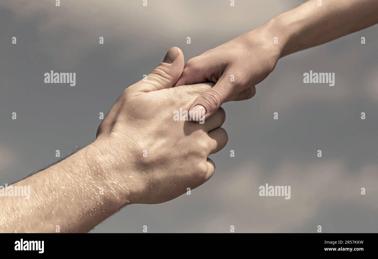 Lending a helping hand. Hands of man and woman reaching to each other ...