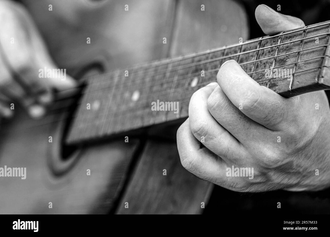 Mans hand playing acoustic guitar Black and White Stock Photos & Images ...