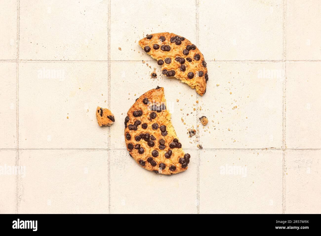 Broken cookie on white tile background Stock Photo - Alamy