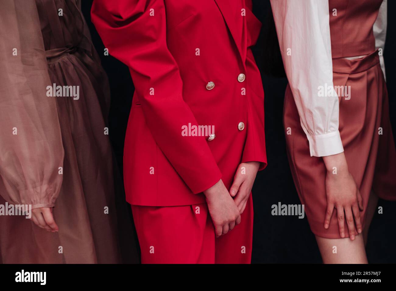 Bright red jacket, brown skirt and lush dress on female bodies. Fashion ...