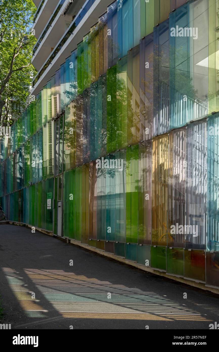 View of a multicolored glass wall with its reflection on the floor ...