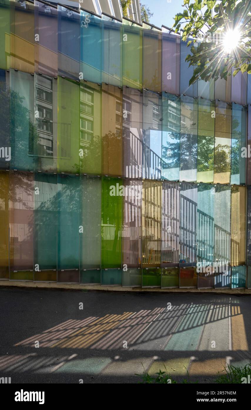 View of a multicolored glass wall with its reflection on the floor ...