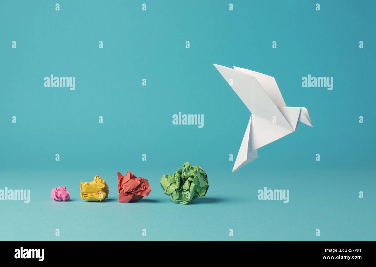 Colorful crumpled paper balls with an origami paper dove, peace ...