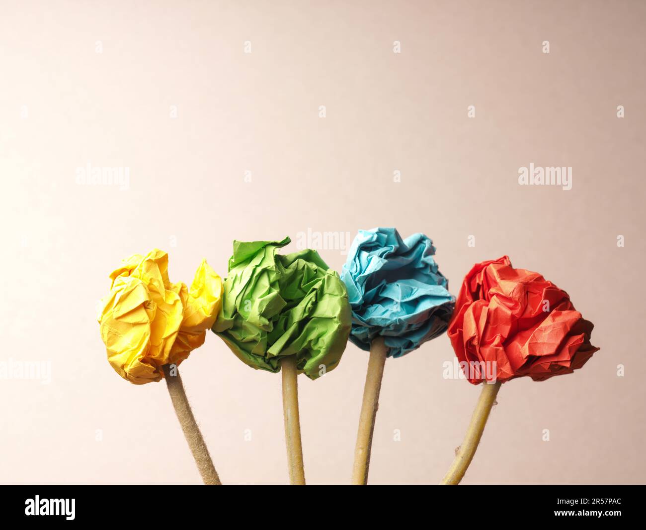 Four flower stems with colorful paper balls as flowers, spring or ...