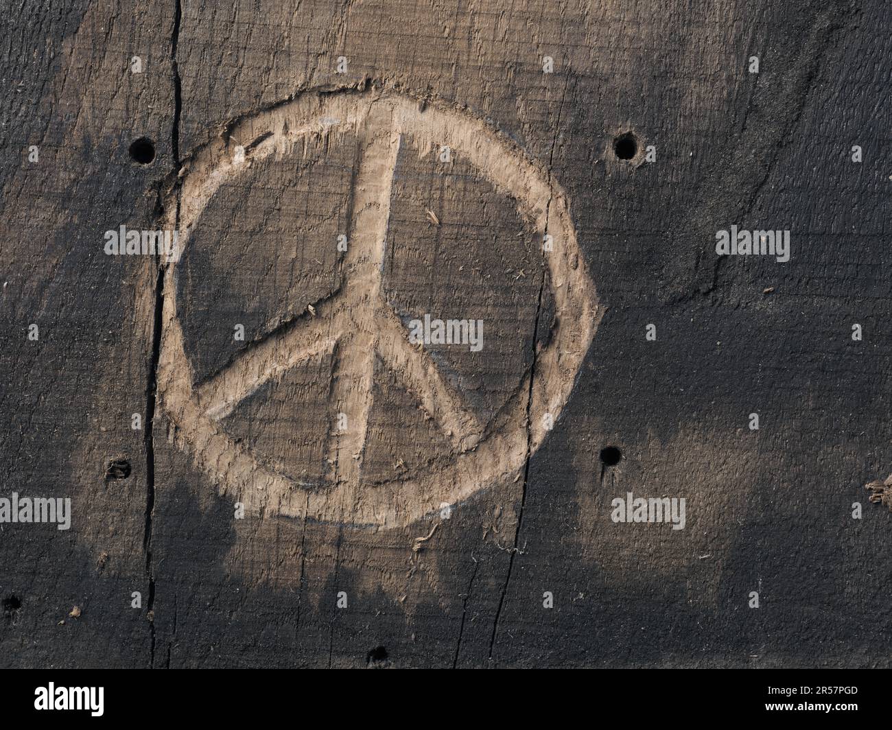 The peace symbol carved in wood with chisels. Peace concept, global ...