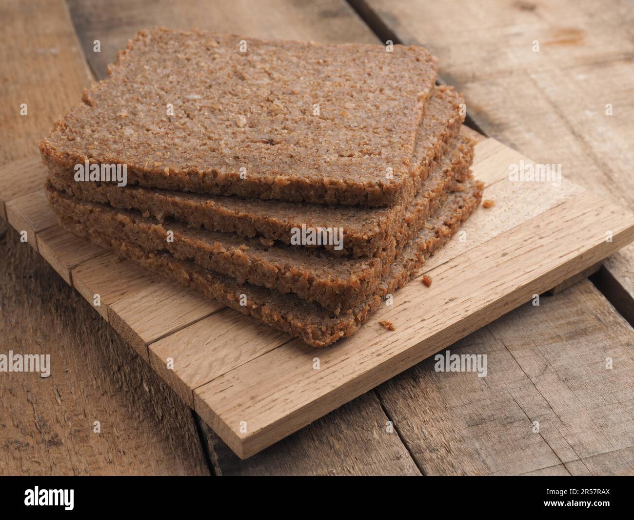 Wholemeal rye bread on a rustic wooden table, healthy food concept ...
