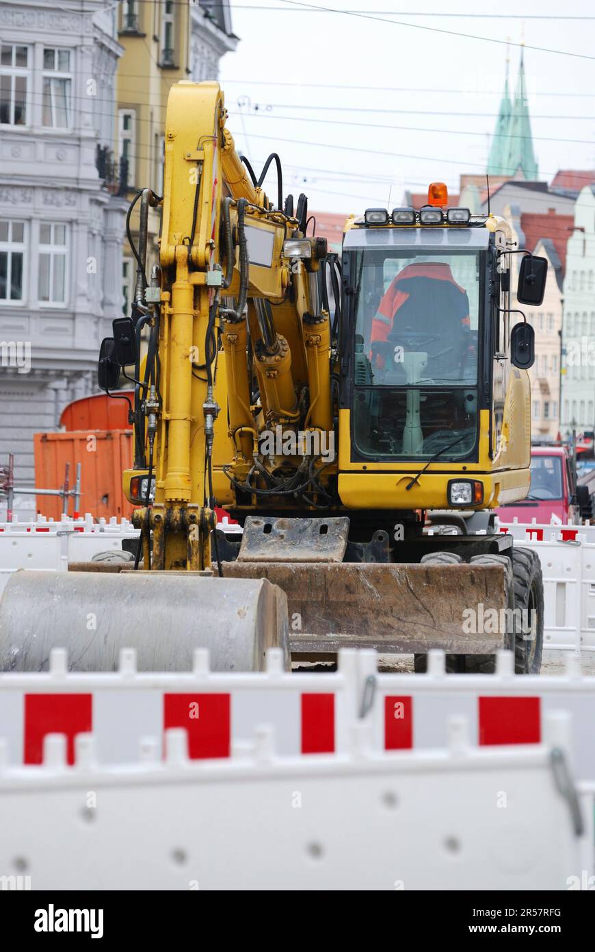 Road works with a digger in the city Stock Photo - Alamy