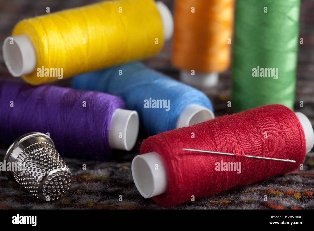 Pile of coloured bobbins of thread Stock Photo - Alamy