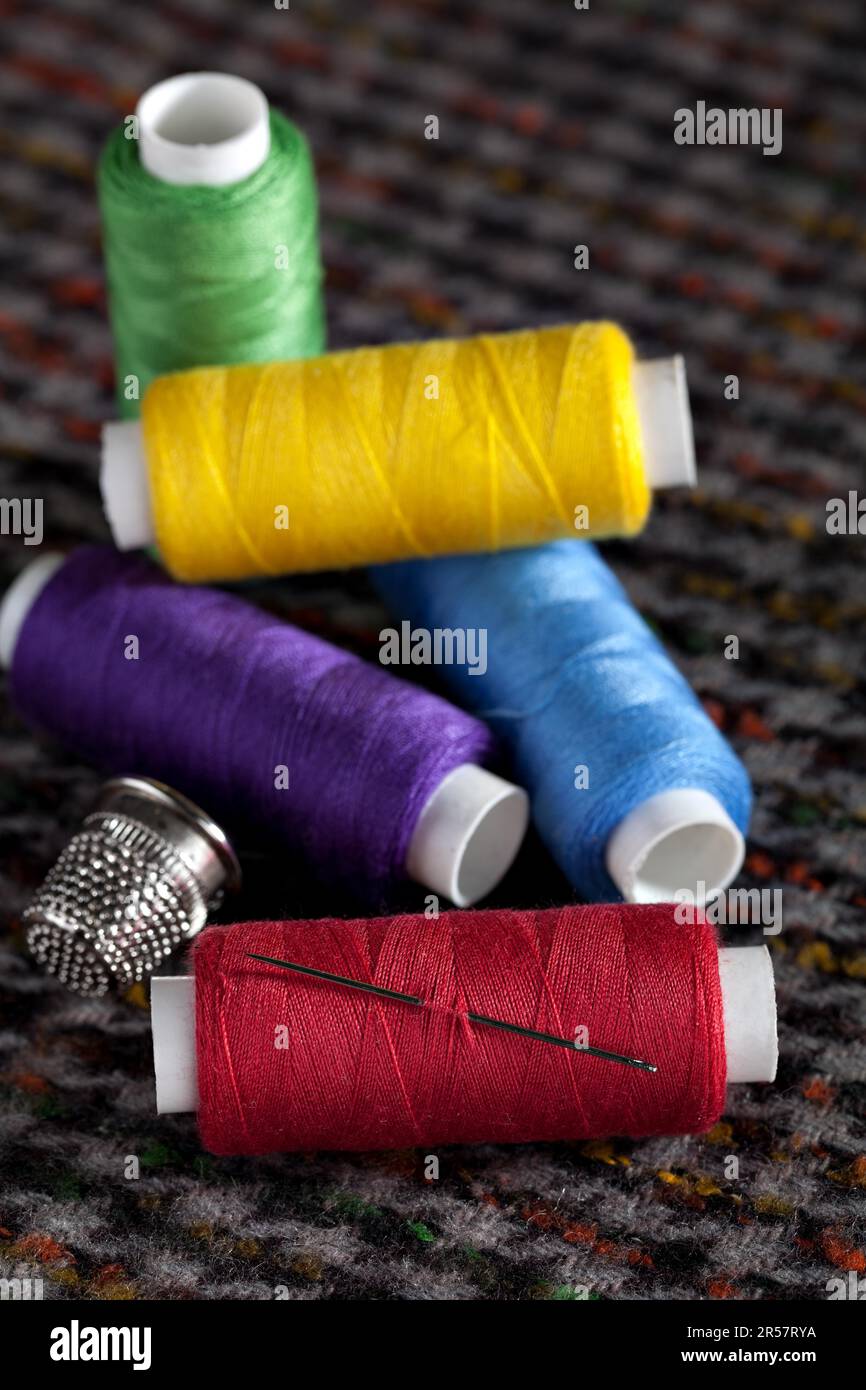 Pile of coloured bobbins of thread Stock Photo - Alamy