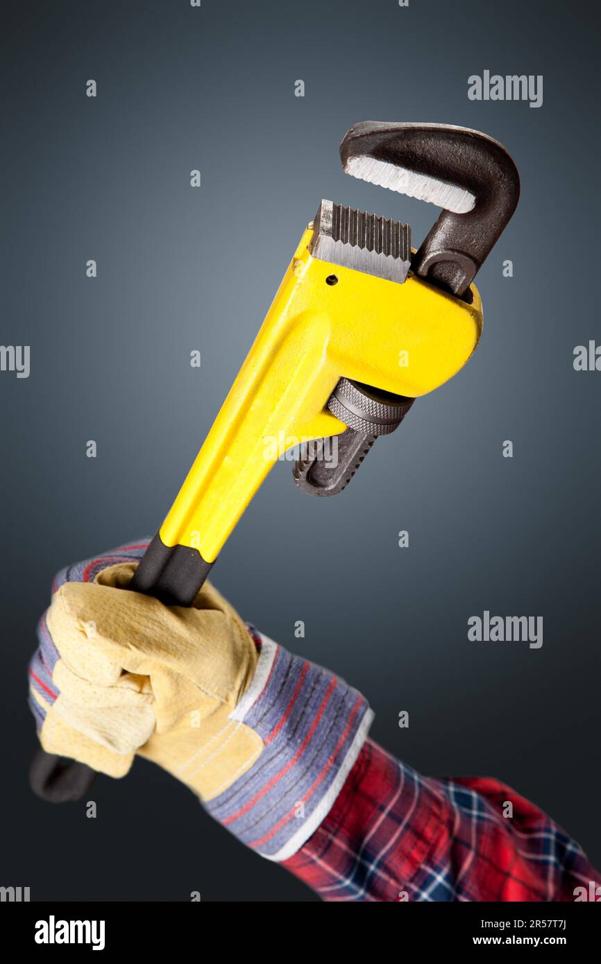 Pipe Wrench in hand Stock Photo - Alamy