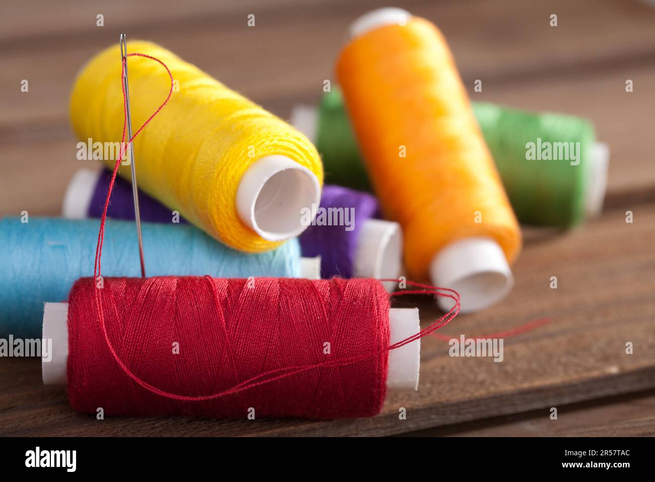 Pile of coloured bobbins of thread Stock Photo - Alamy