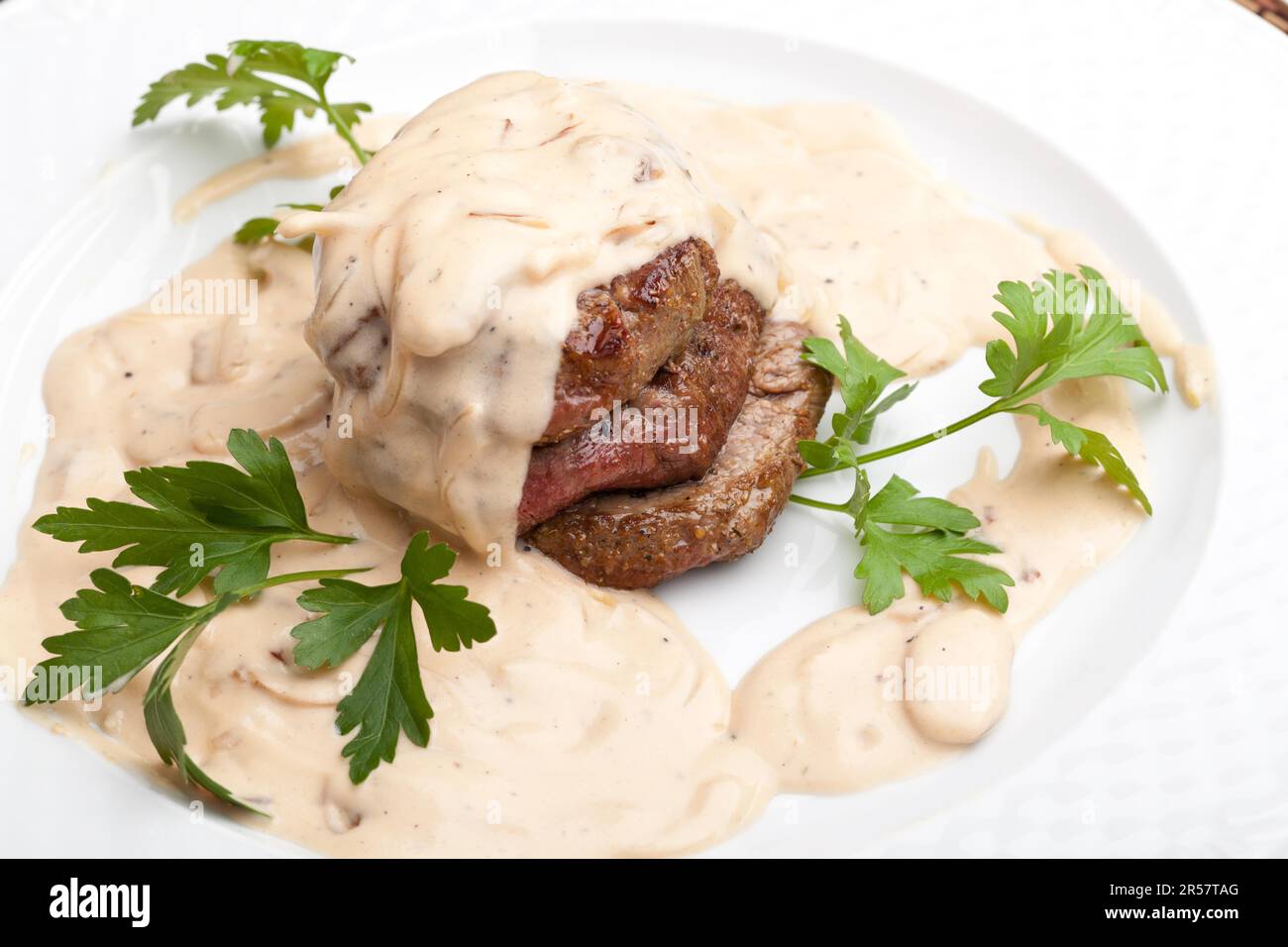 Roasted meat under white sauce Stock Photo - Alamy