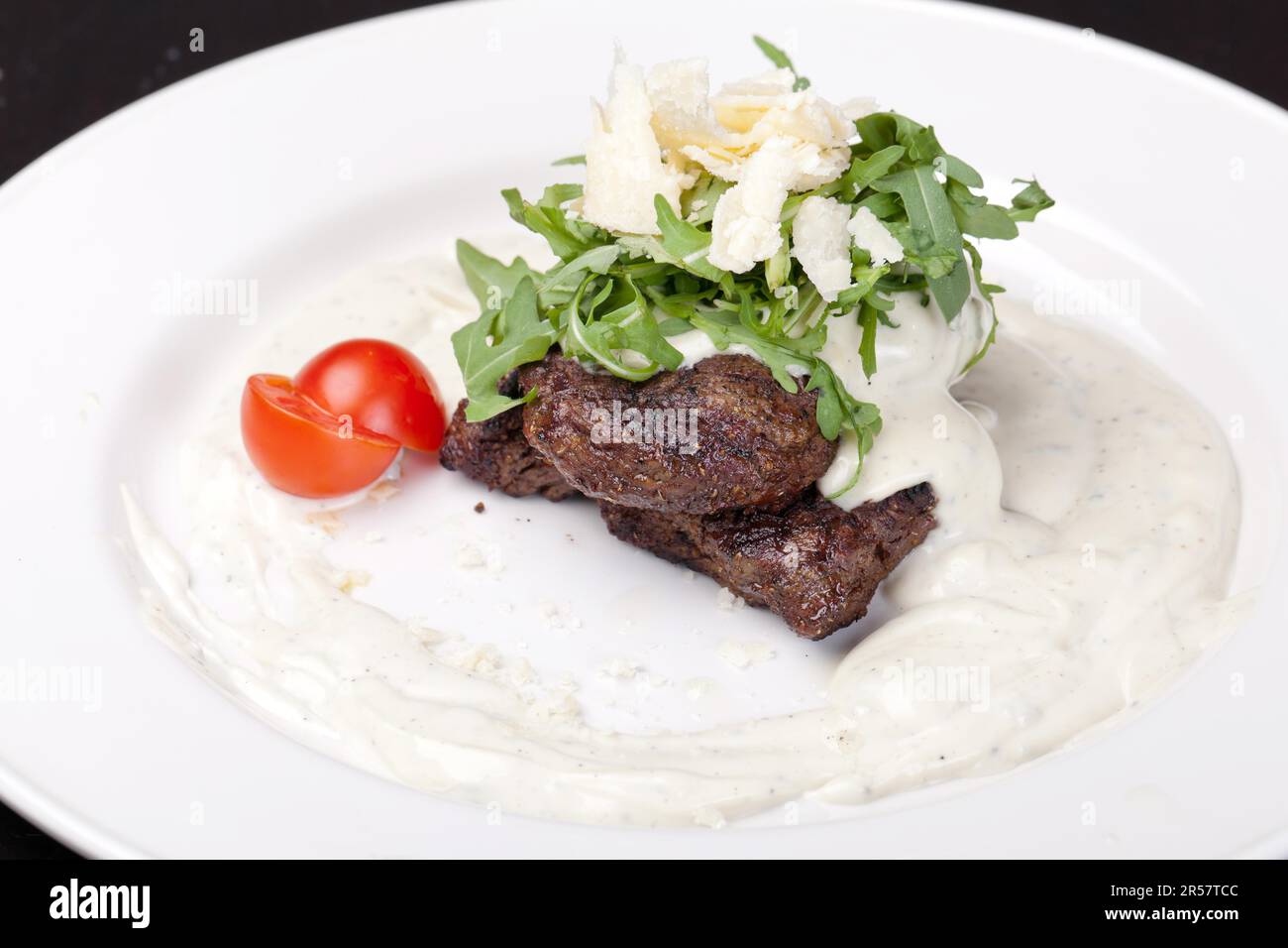 Roasted meat under cheese sauce Stock Photo - Alamy