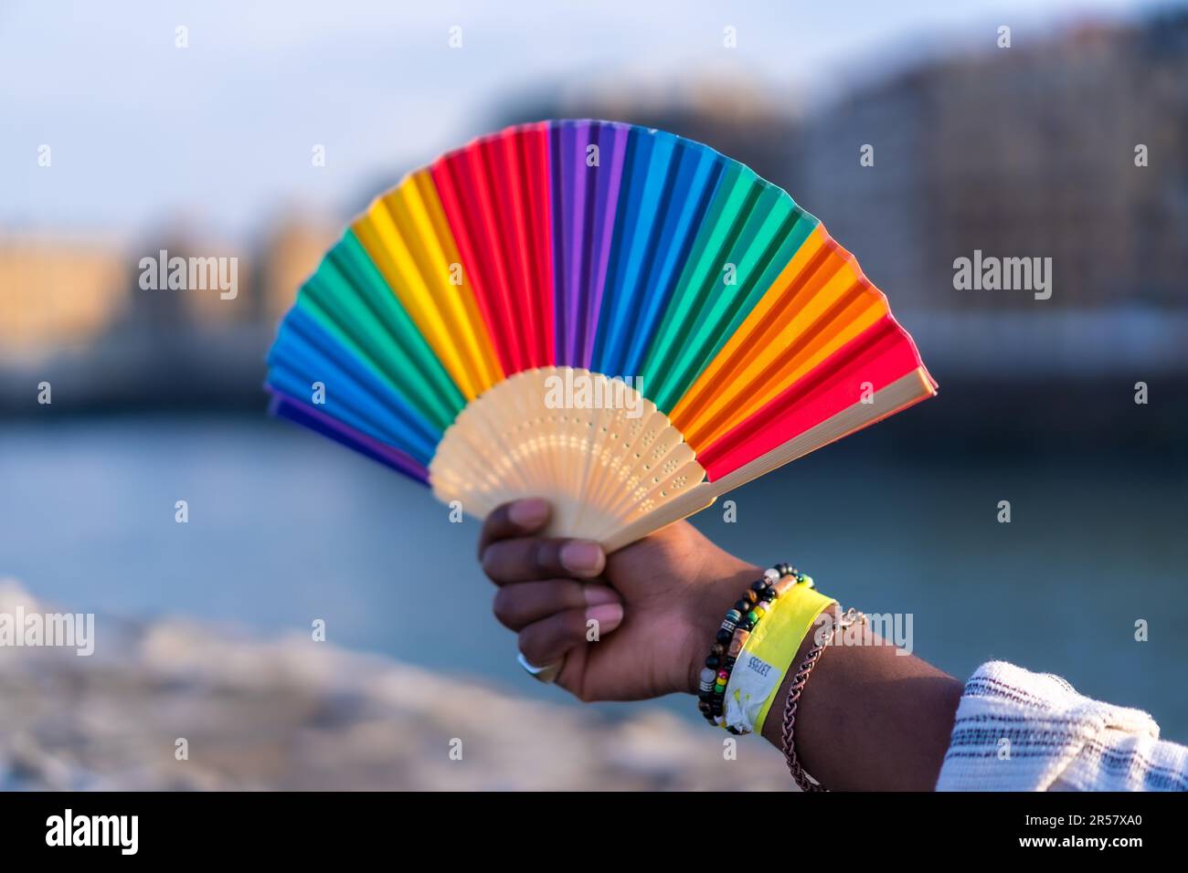Colorful rainbow fan during gay pride, LGBT collective fan by the sea ...