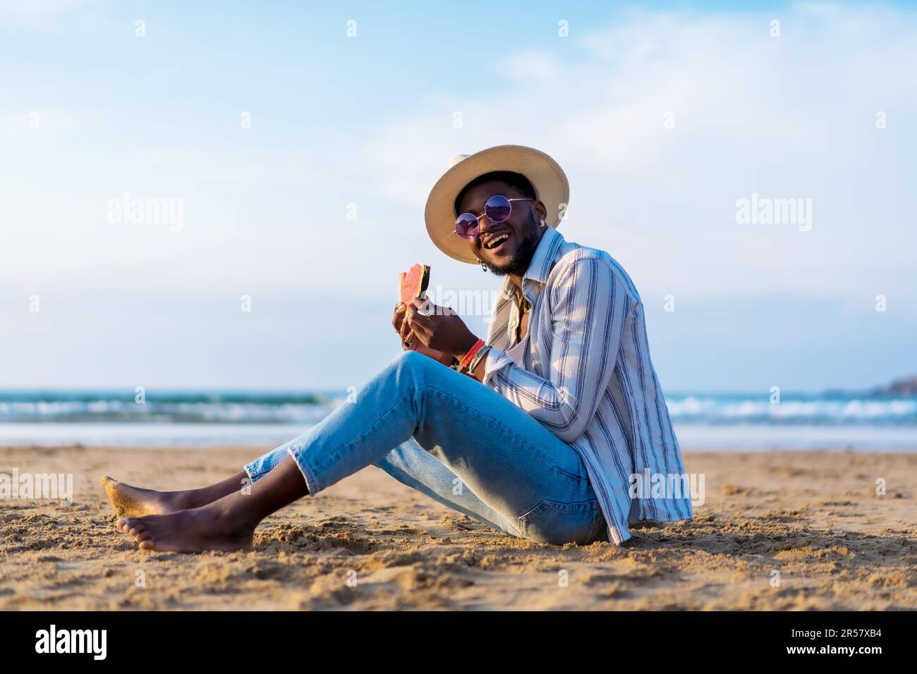 Portrait of a black ethnic man enjoy summer vacation at the beach ...