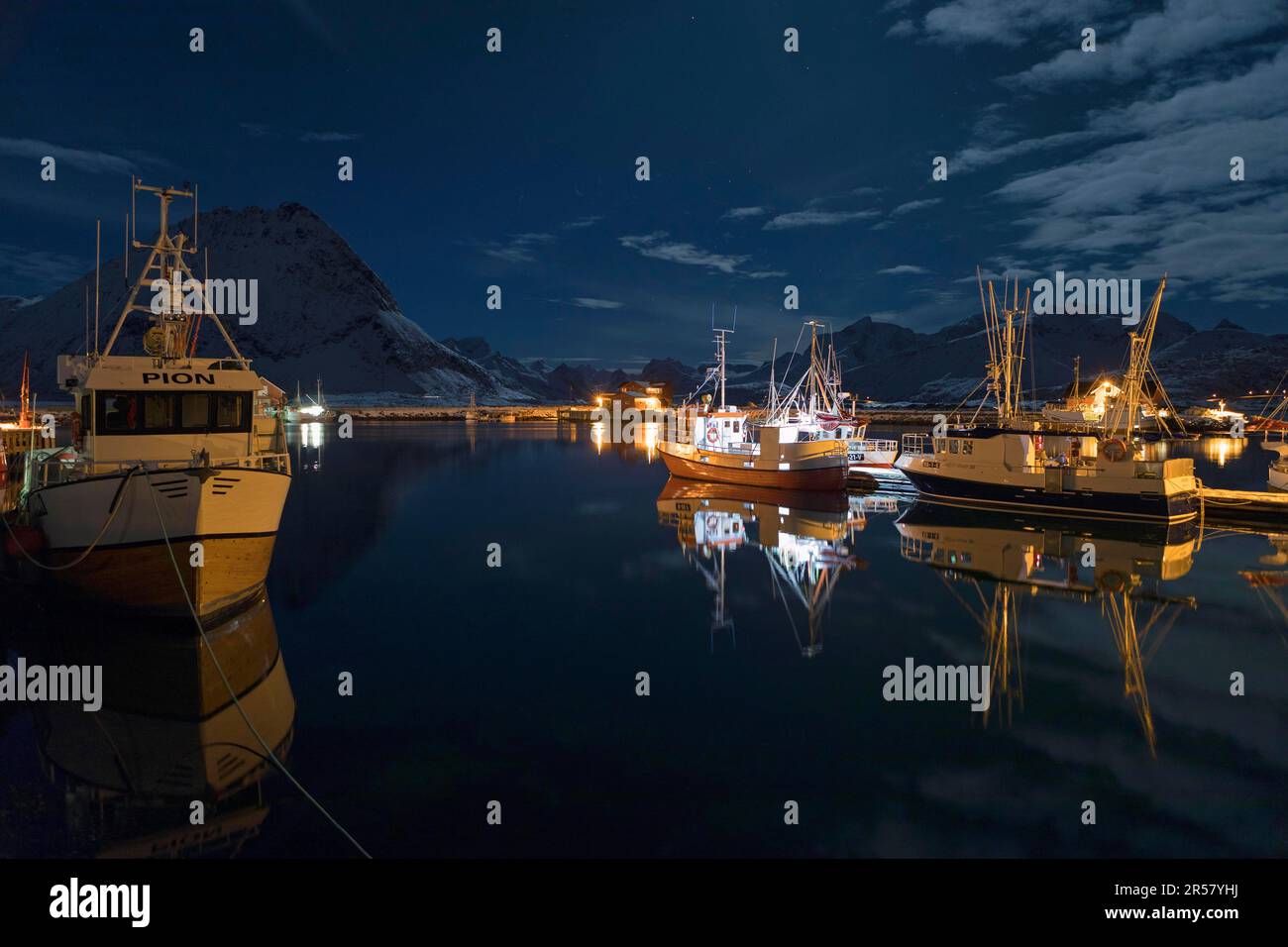 Water reflection in Ramberg harbour on New Year's Eve, Lofoten, Norway ...