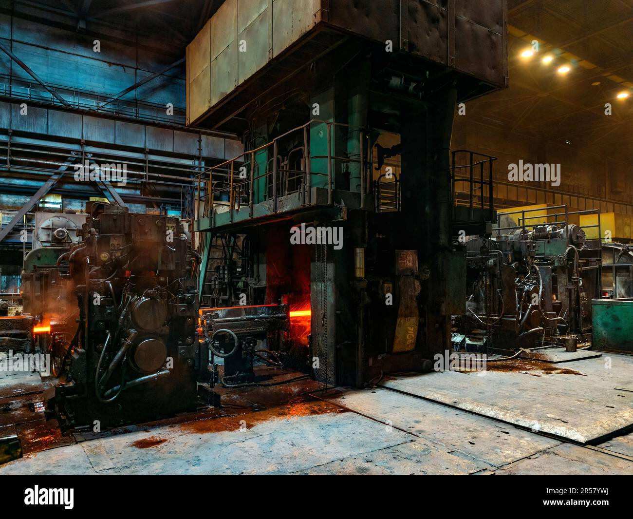 Rolled metal factory hot steel bar on conveyor moving through rollers ...