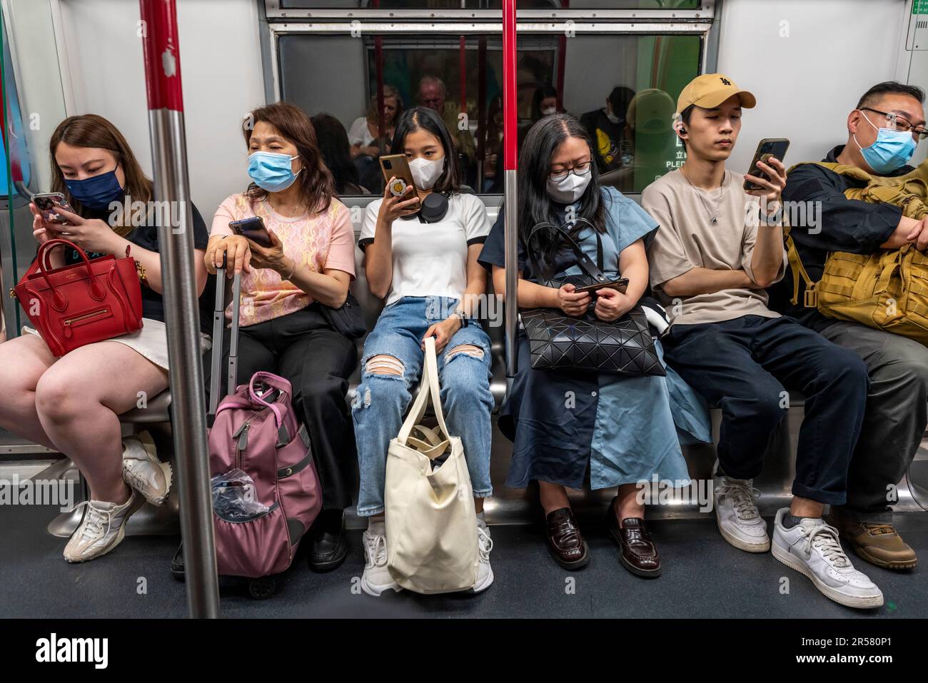 People Using Their Smartphones On A MTR Train, Hong Kong, China Stock ...