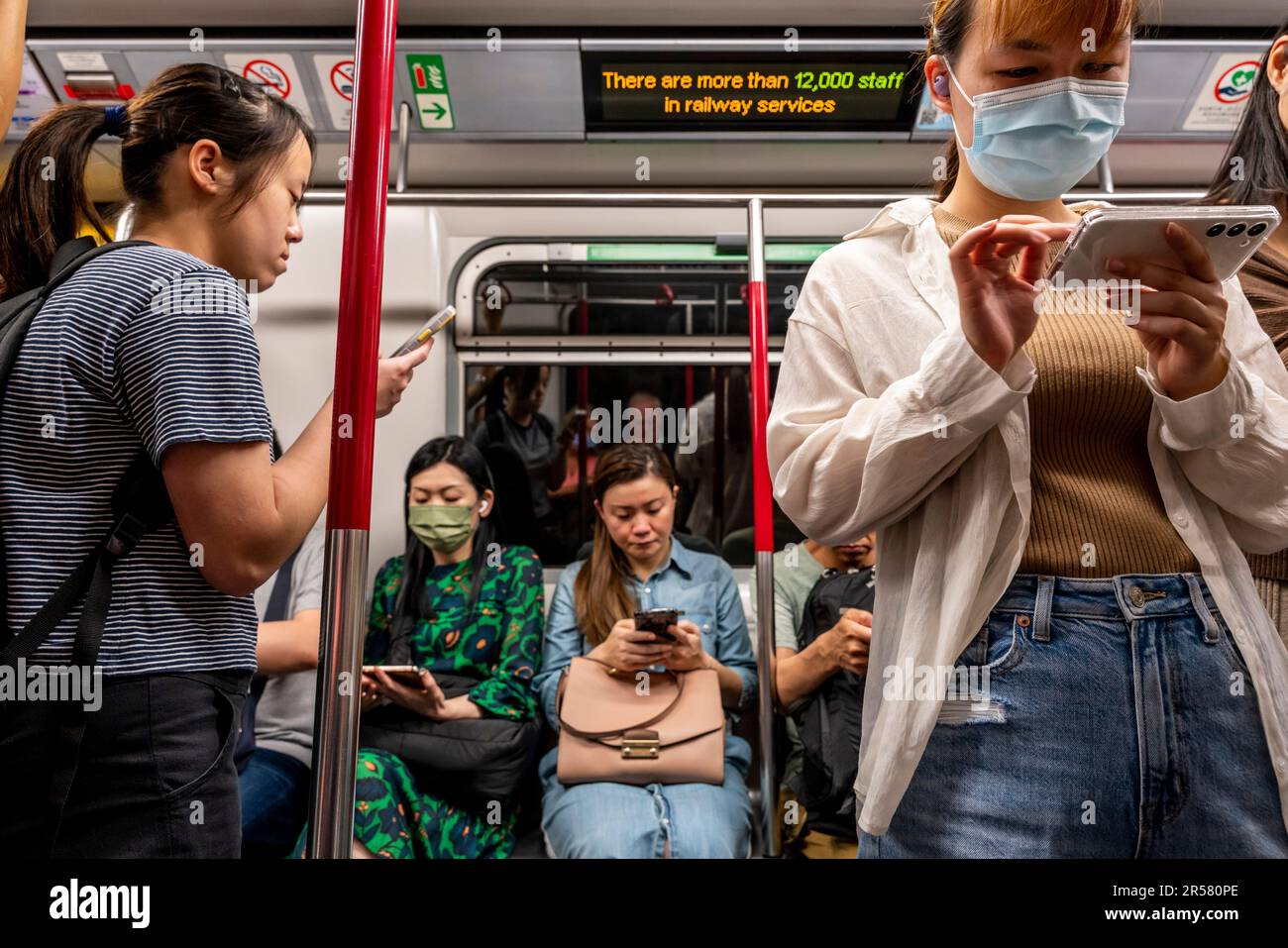People Using Their Smartphones On A MTR Train, Hong Kong, China Stock ...