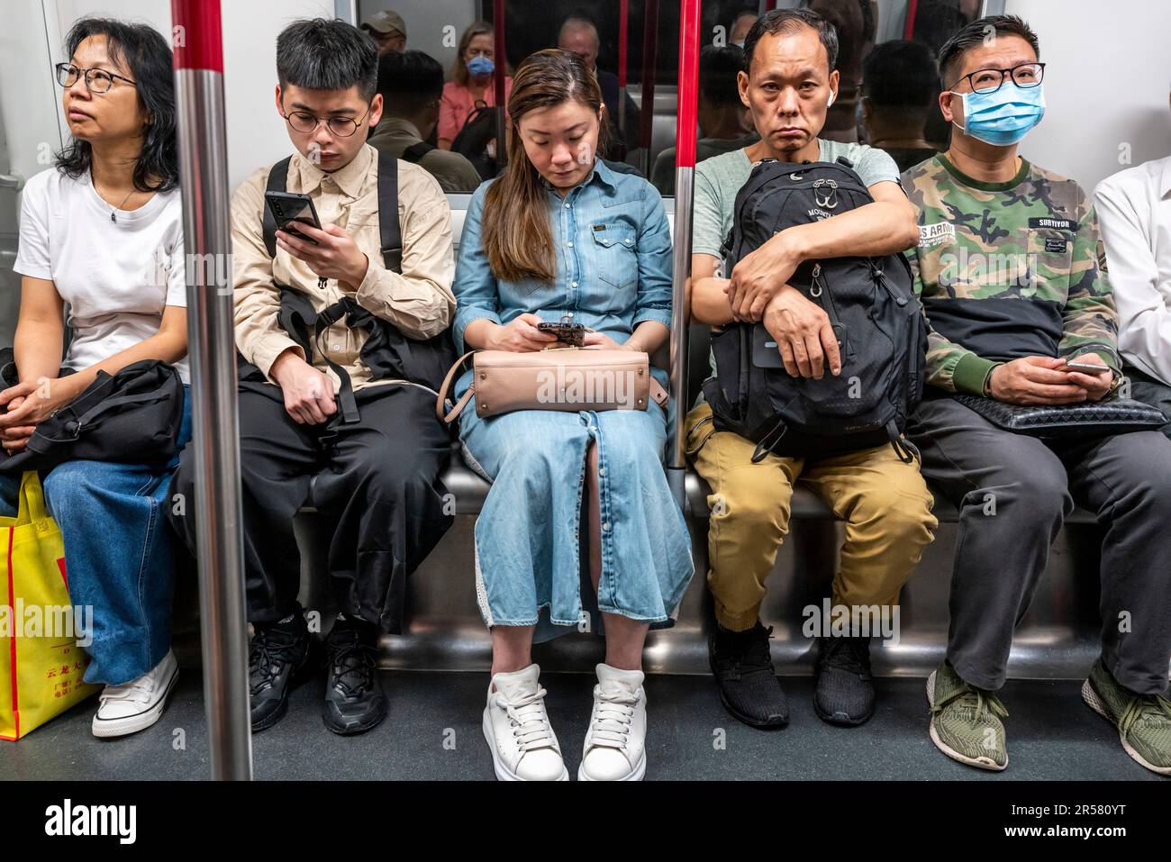 People Using Their Smartphones On A MTR Train, Hong Kong, China Stock ...