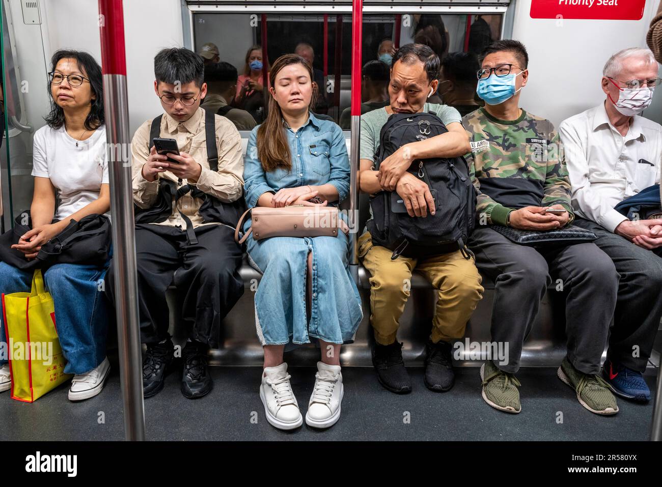 People Using Their Smartphones On A MTR Train, Hong Kong, China Stock ...