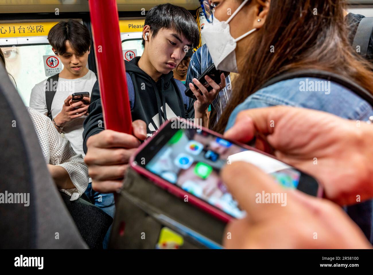 People Using Their Smartphones On A MTR Train, Hong Kong, China Stock ...